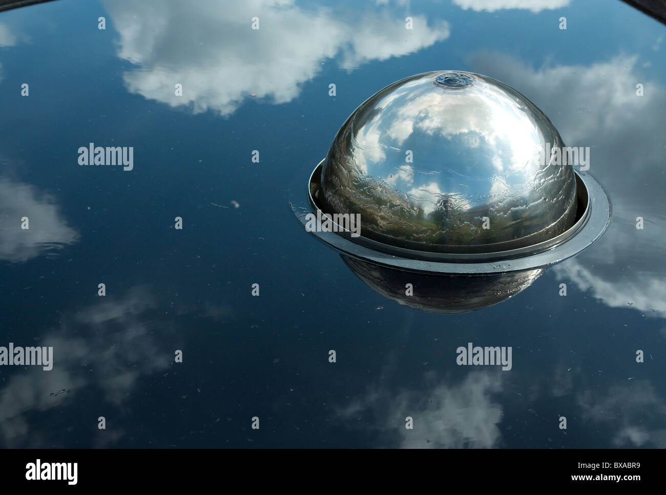 Silver water feature with reflected sky Stock Photo - Alamy