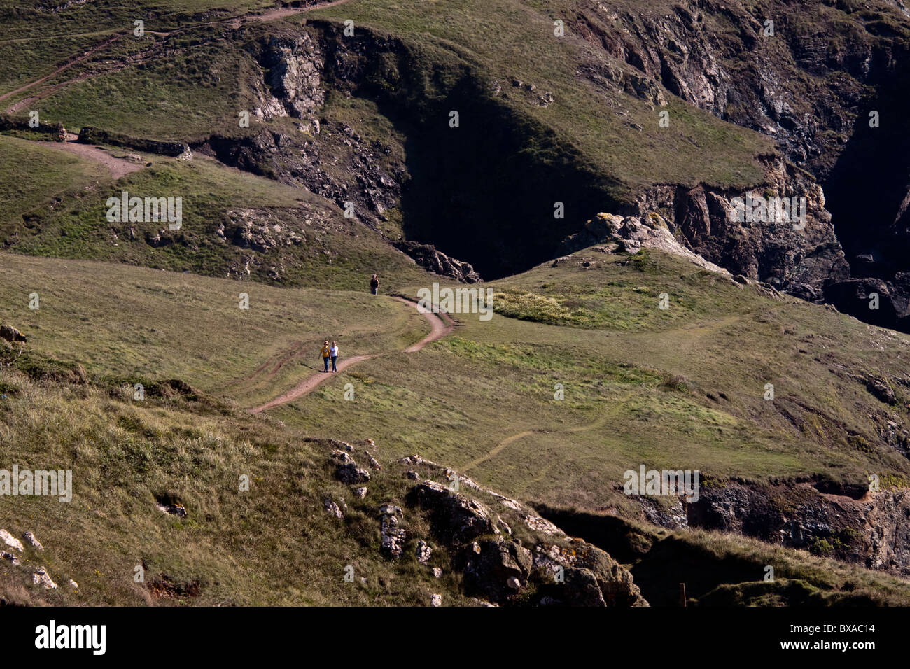 walkers enjoying the coastal path at Lizard Point in Cornwall Stock ...