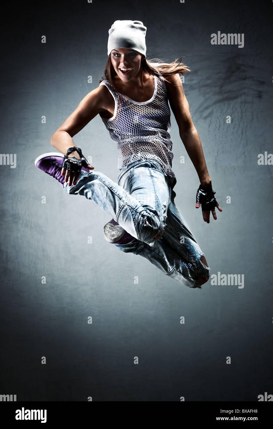 Young woman dancer jumping. On wall background Stock Photo - Alamy