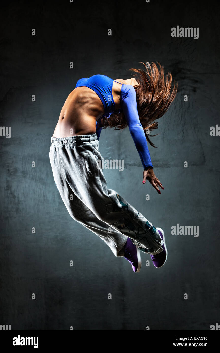 Young woman dancer jumping. On wall background Stock Photo - Alamy