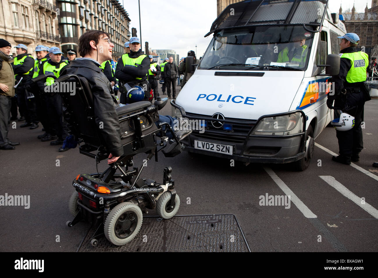 Disabled man in wheelchair in front of police during Tuition fees ...
