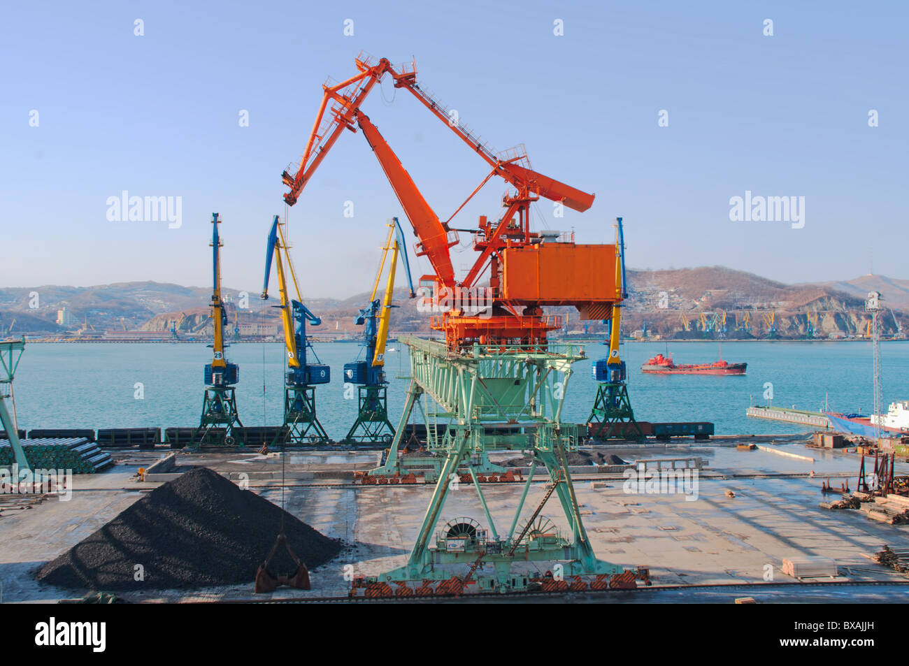 The cargo crane in sea port for loading of bulk cargoes. A city ...