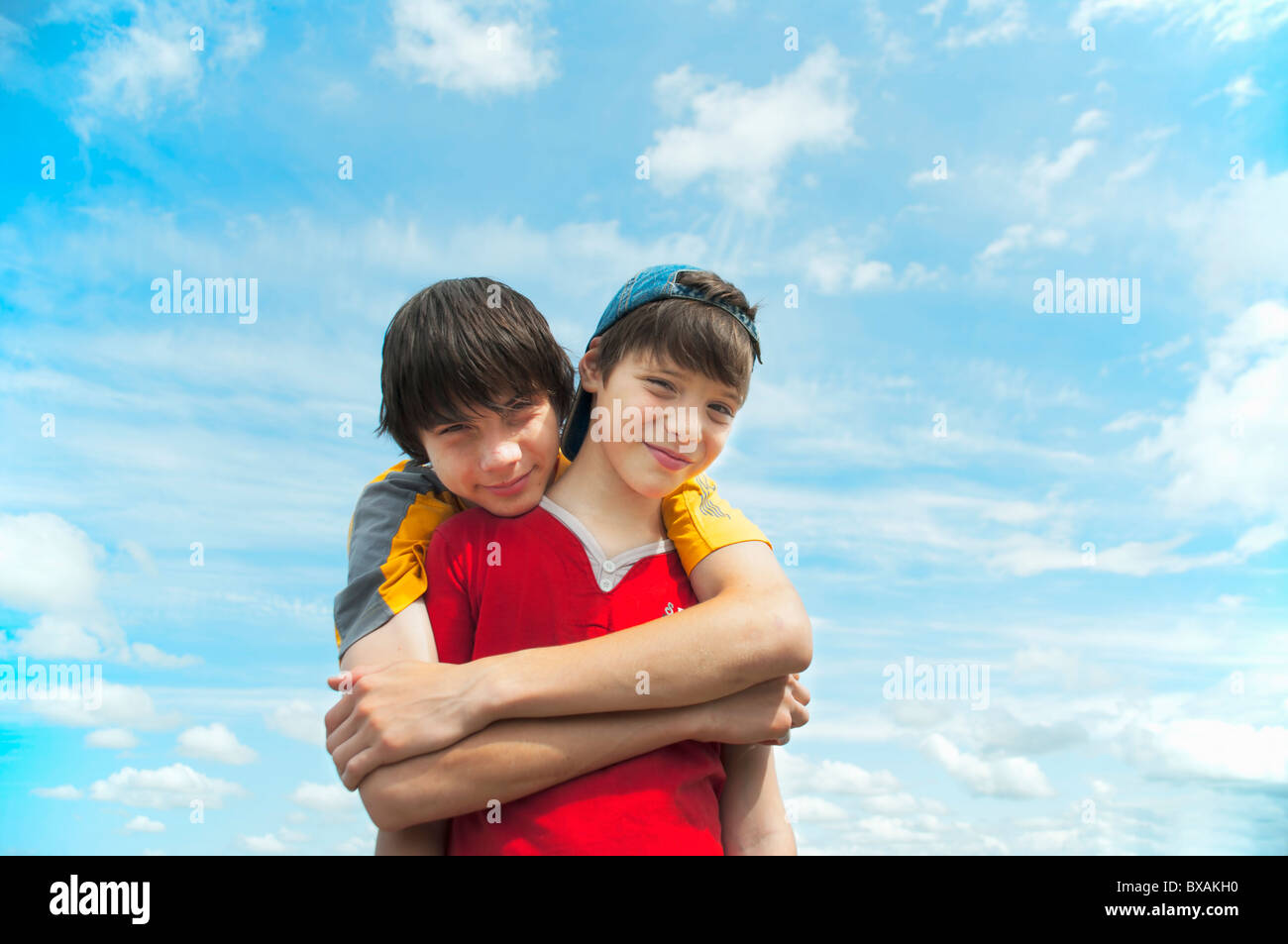 Two brothers against the dark blue sky Stock Photo - Alamy