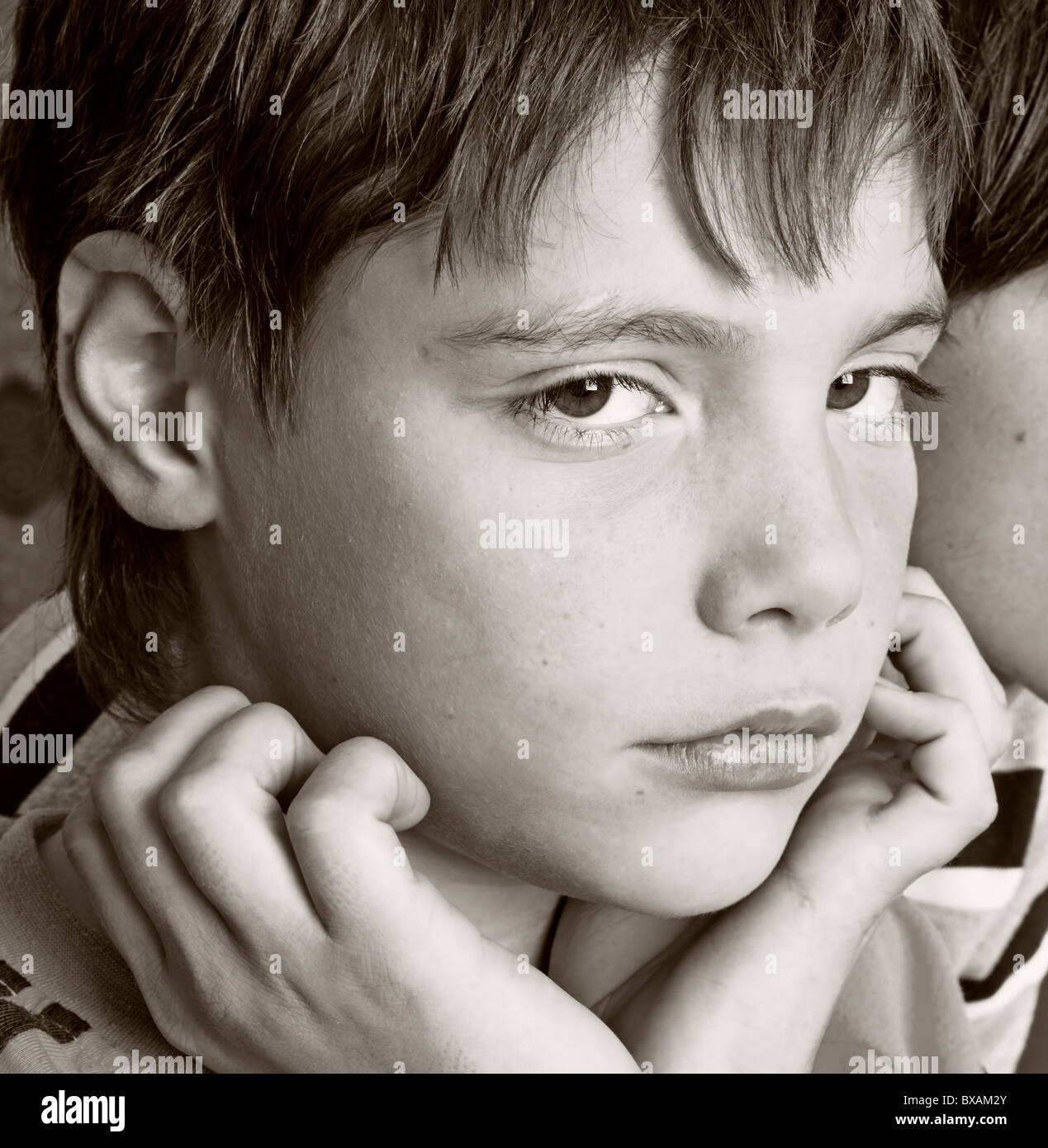 The sad boy looks having leant against hands Stock Photo - Alamy
