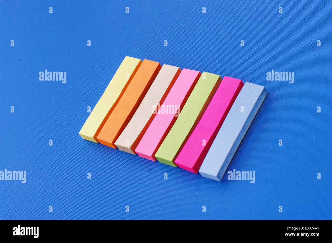 Multi-coloured stickers on a blue background Stock Photo - Alamy