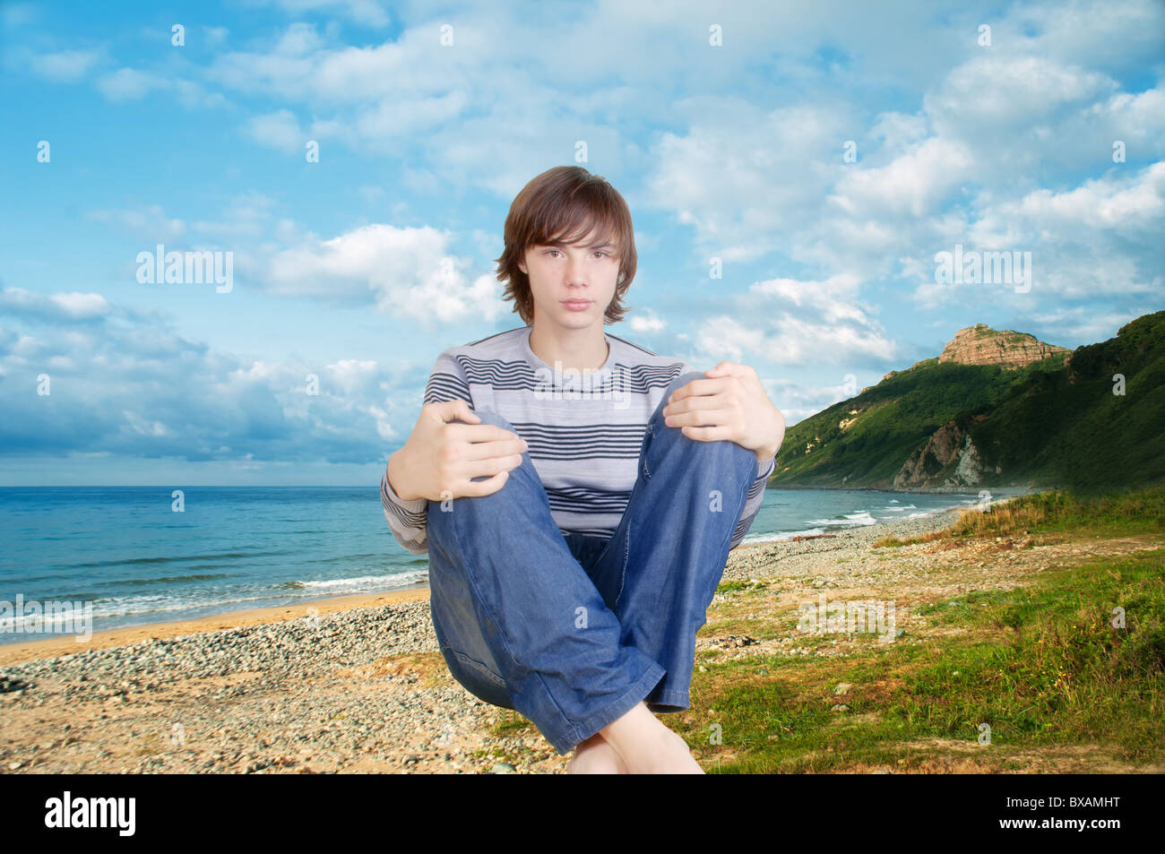 The teenager on seacoast looking afar Stock Photo - Alamy