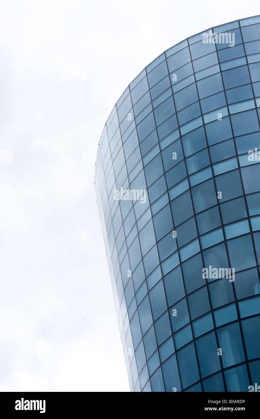 a half round glass multistory building widened upwards Stock Photo - Alamy