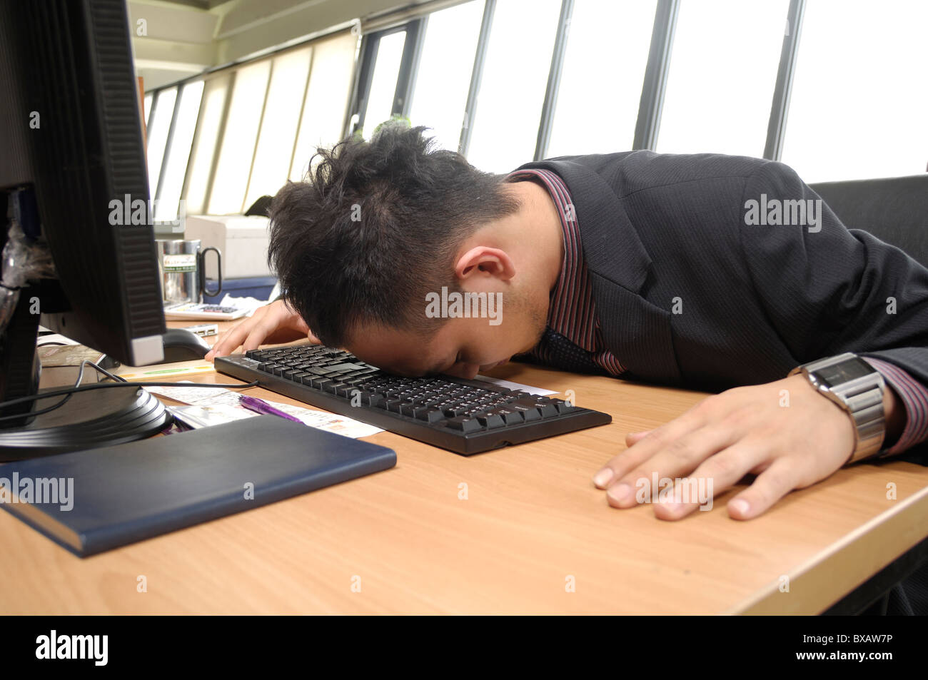 Businessman napping on the desk Stock Photo - Alamy