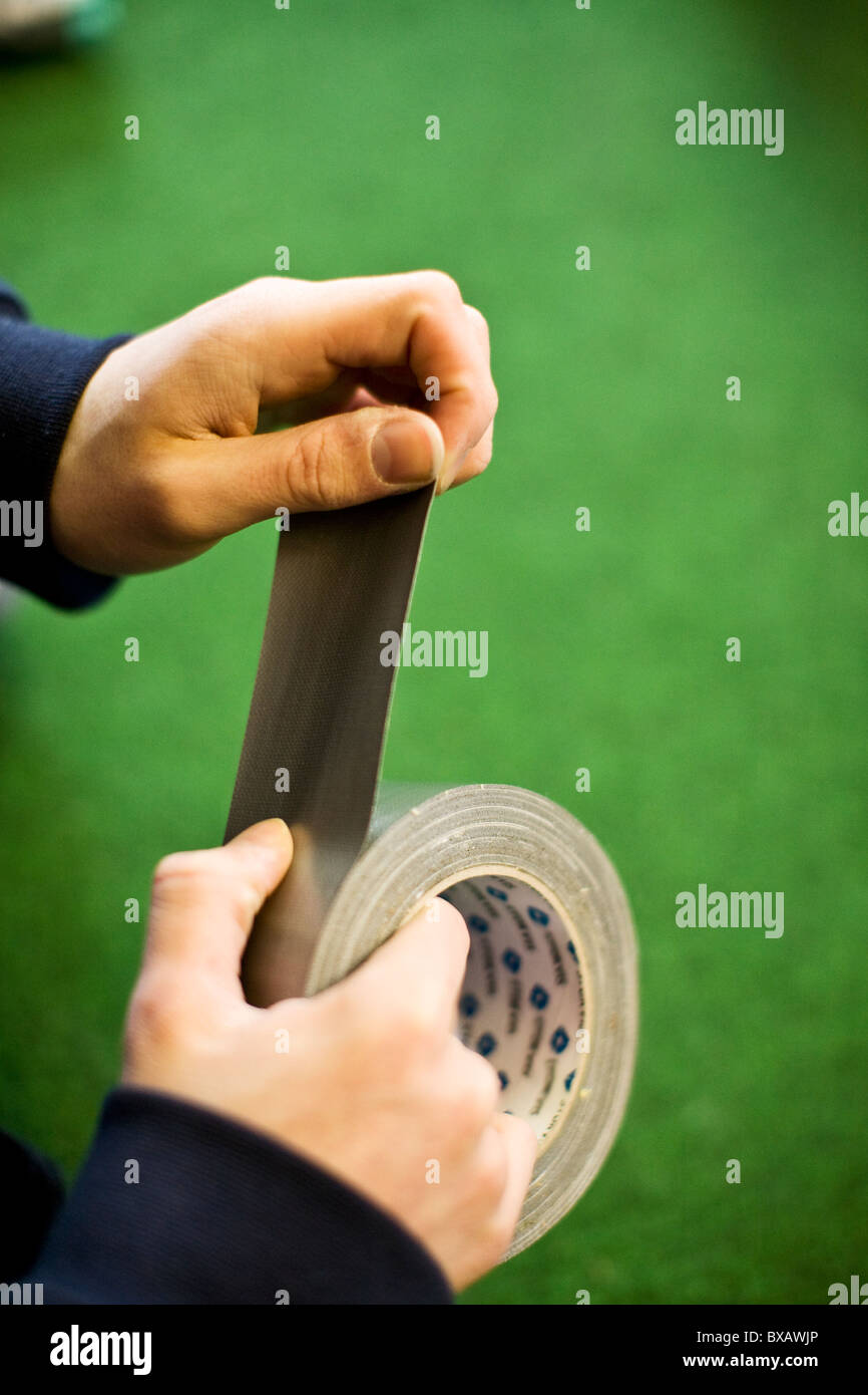Close-up view of man hands holding sticky tape Stock Photo - Alamy