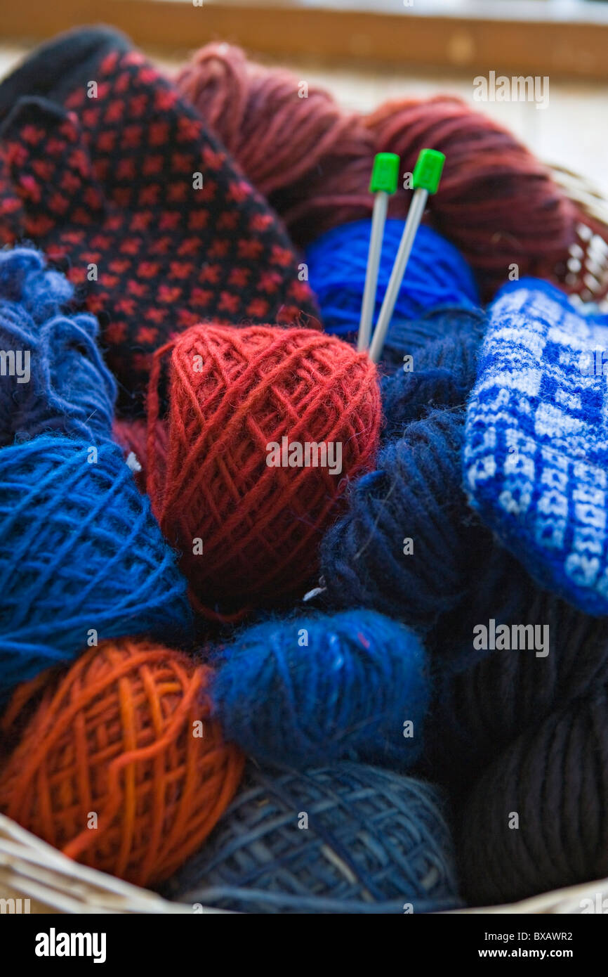 Basket full of wool balls, with knitting needles stuck in Stock Photo ...