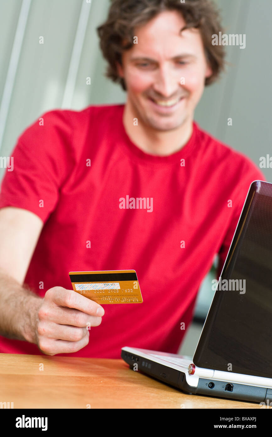 Mid-adult man online shopping Stock Photo - Alamy