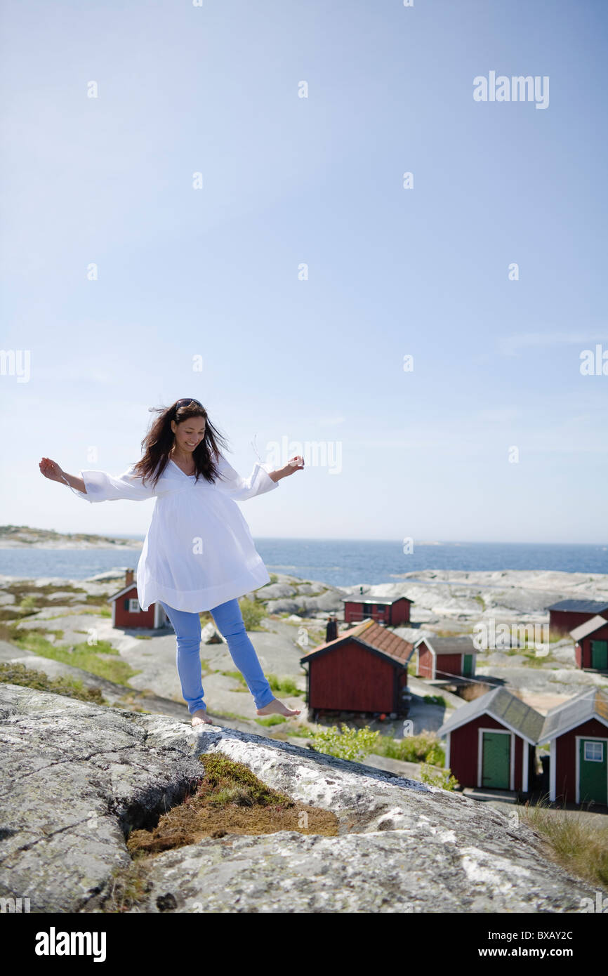 Woman standing on rock, smiling Stock Photo - Alamy