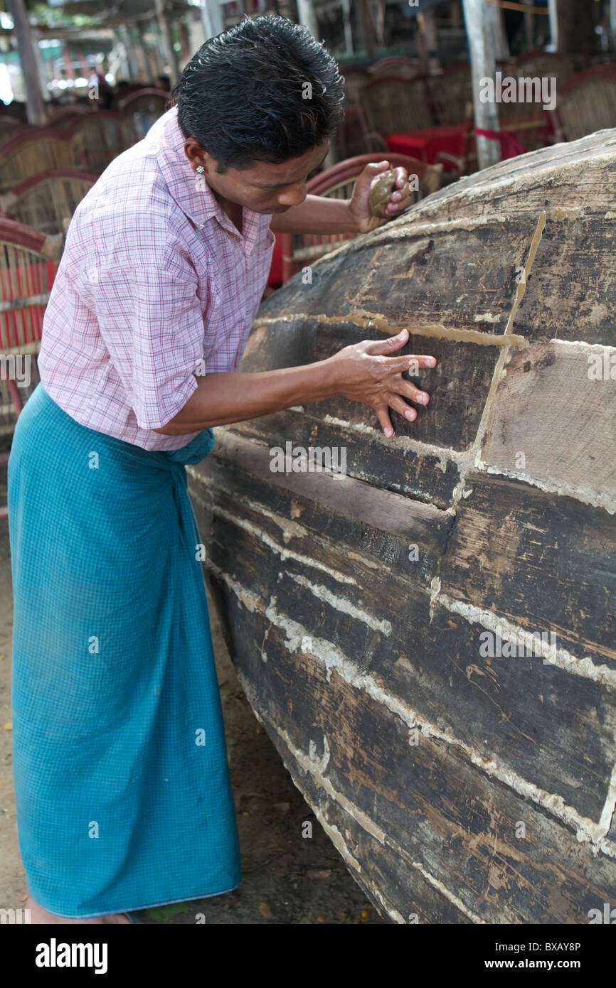 man fixing a small boat Stock Photo - Alamy