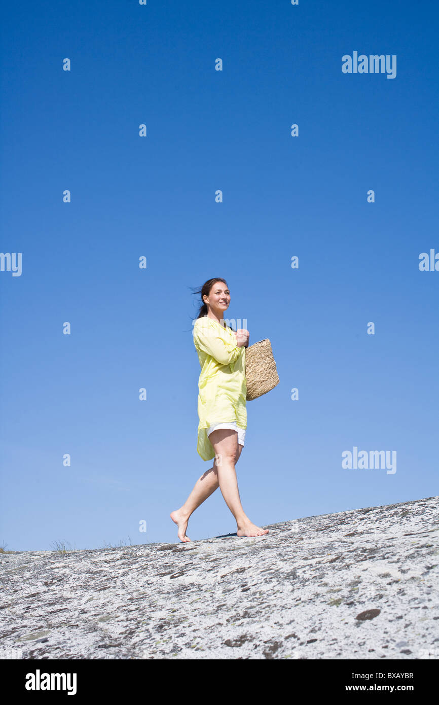 Woman walking on rock Stock Photo - Alamy