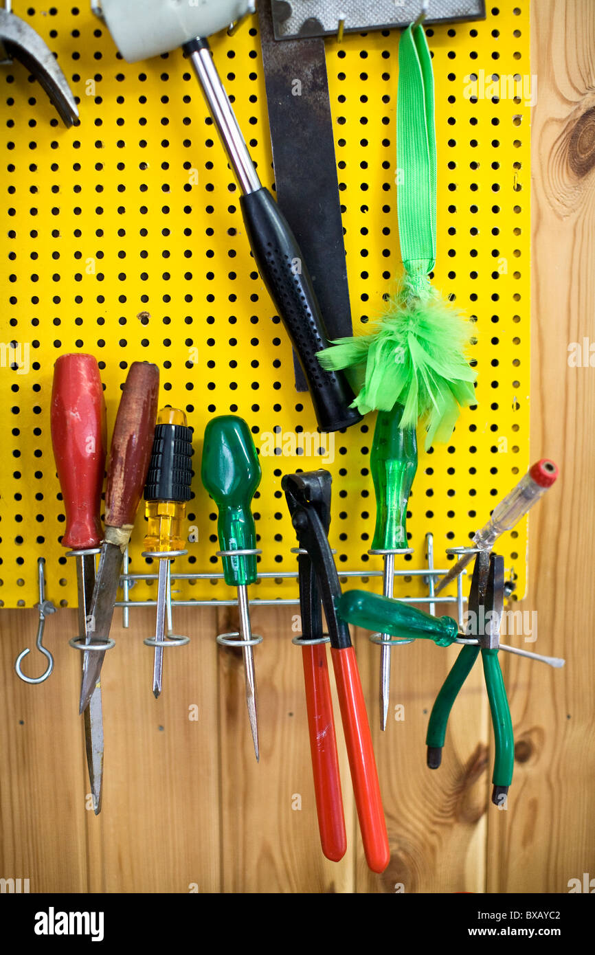 Variety of worktools hanging on board attached to wood panel Stock ...