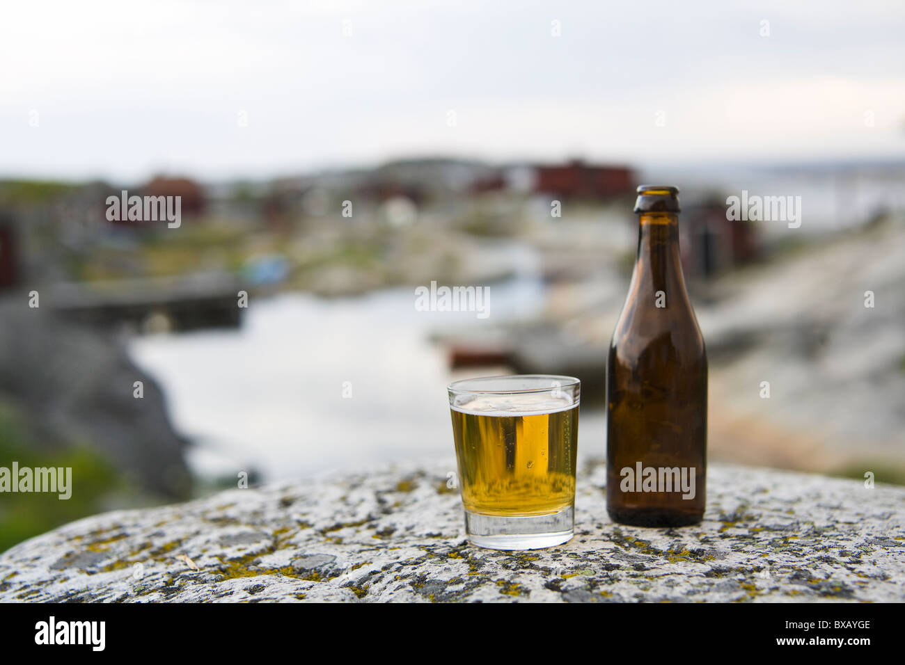 Beer bottle and glass on rock Stock Photo - Alamy