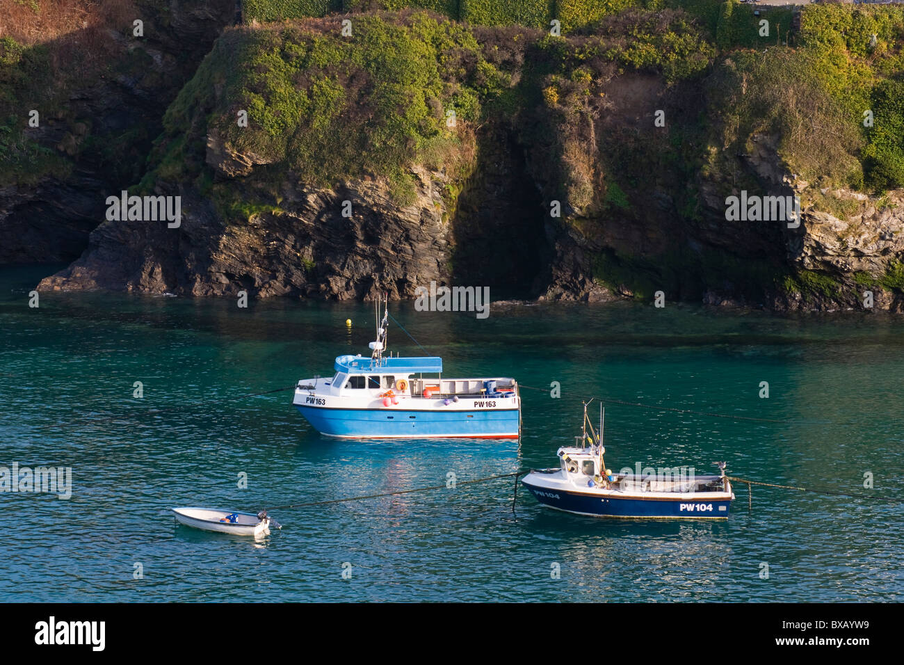 A set of fishing boats at anchor in the harbour at Port Isaac on the ...