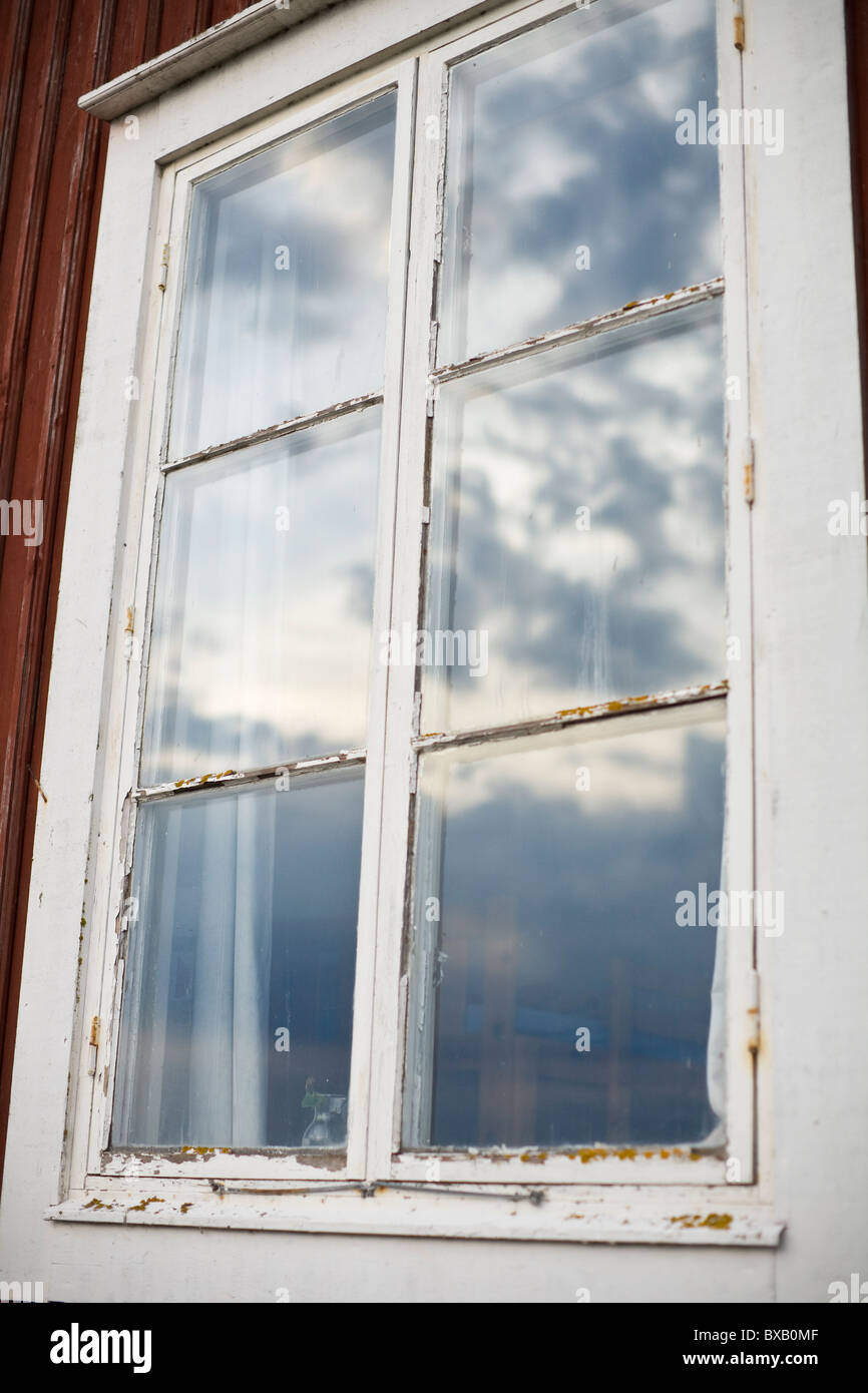 Reflection of sky on old window Stock Photo - Alamy