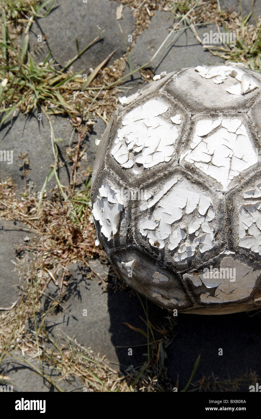 one old damaged football in field Stock Photo - Alamy