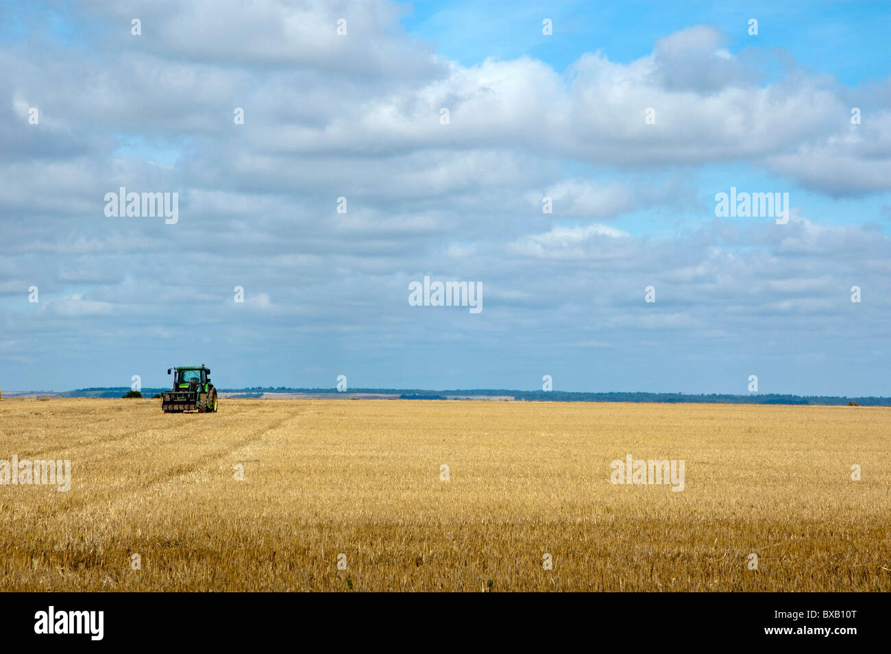 Tractor parked in harvested corn field, Normandy, France Stock Photo ...