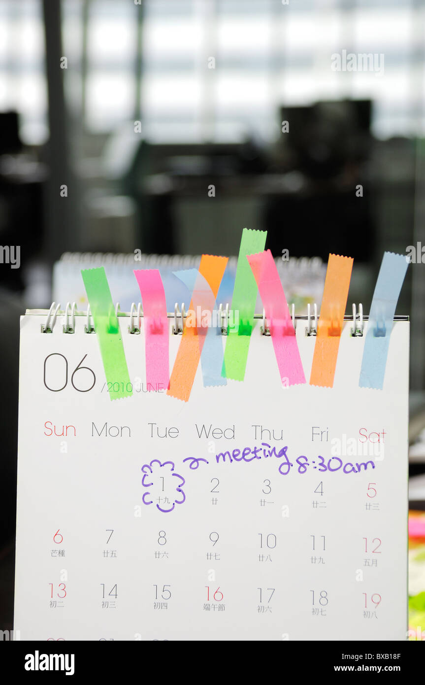 Adhesive notes stuck on a calendar Stock Photo - Alamy