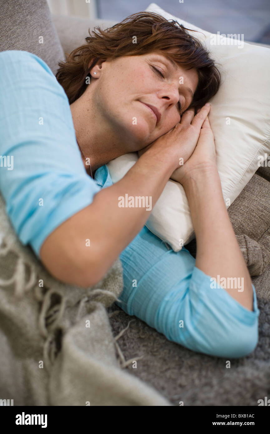 Woman sleeping on sofa Stock Photo - Alamy