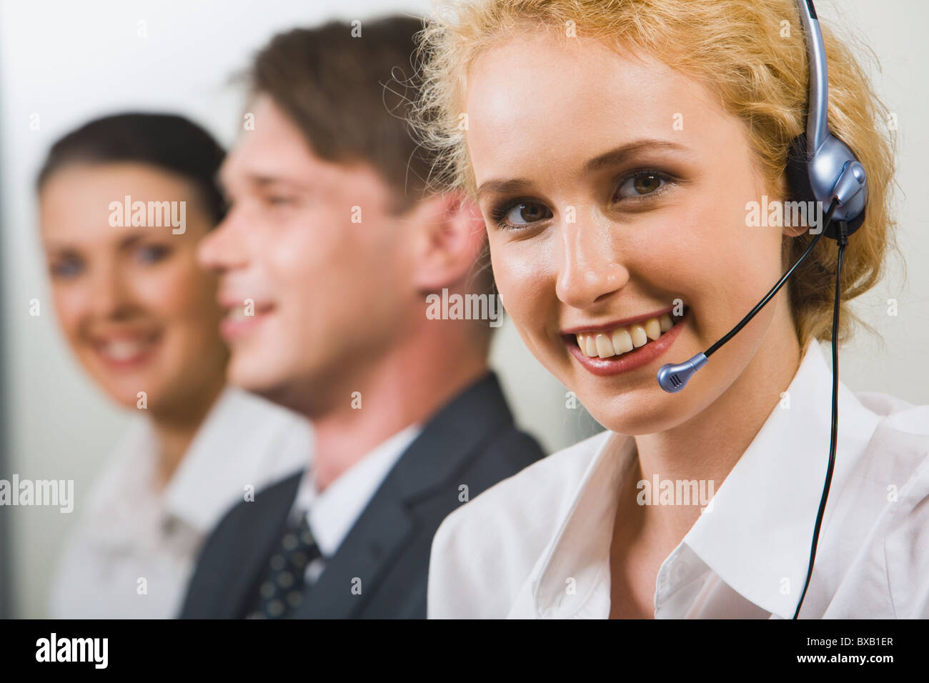A friendly smiling customer support operator on a background of two ...