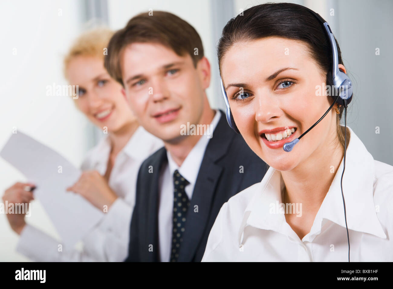 Friendly customer support team in an office environment Stock Photo - Alamy