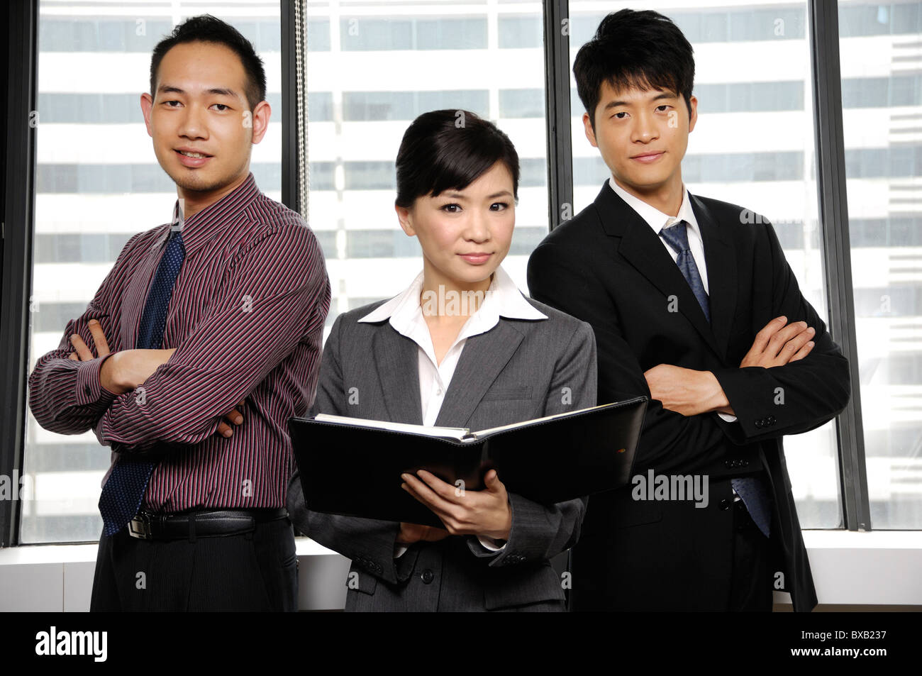 Business executives standing in an office Stock Photo - Alamy