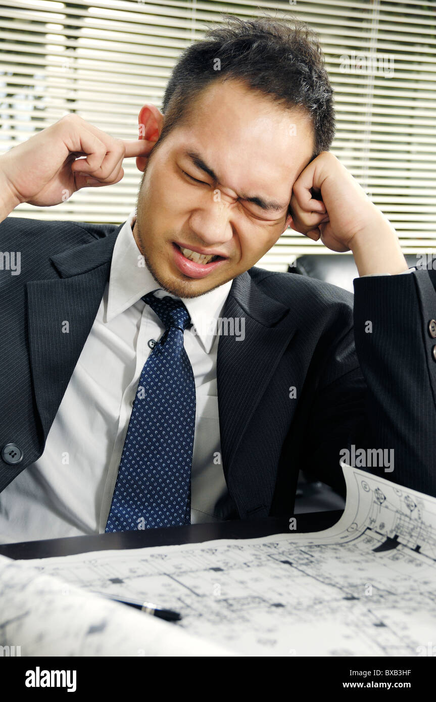 Architect looking frustrated in an office Stock Photo - Alamy