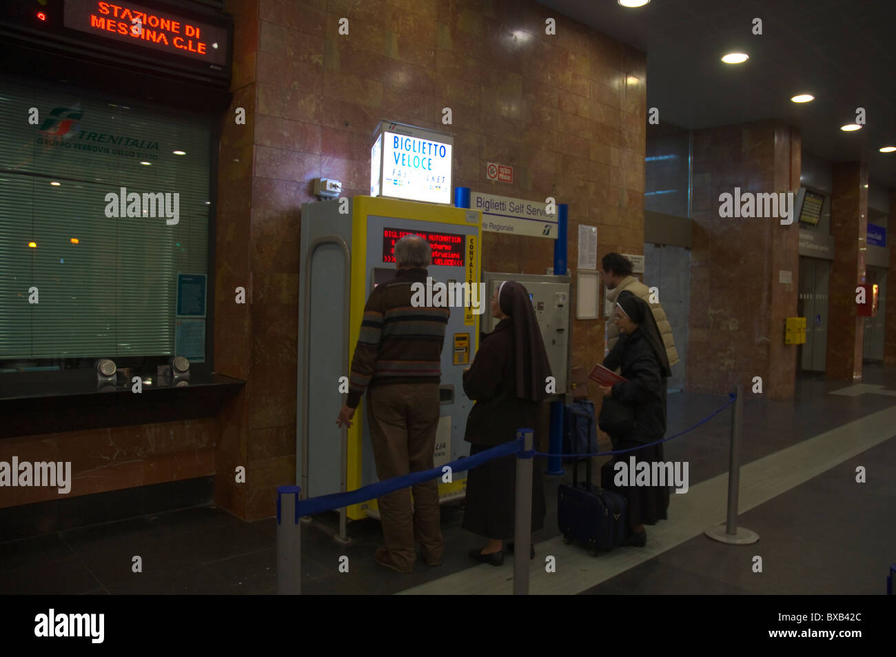 People buying self-service tickets at Messina centrale railway station ...