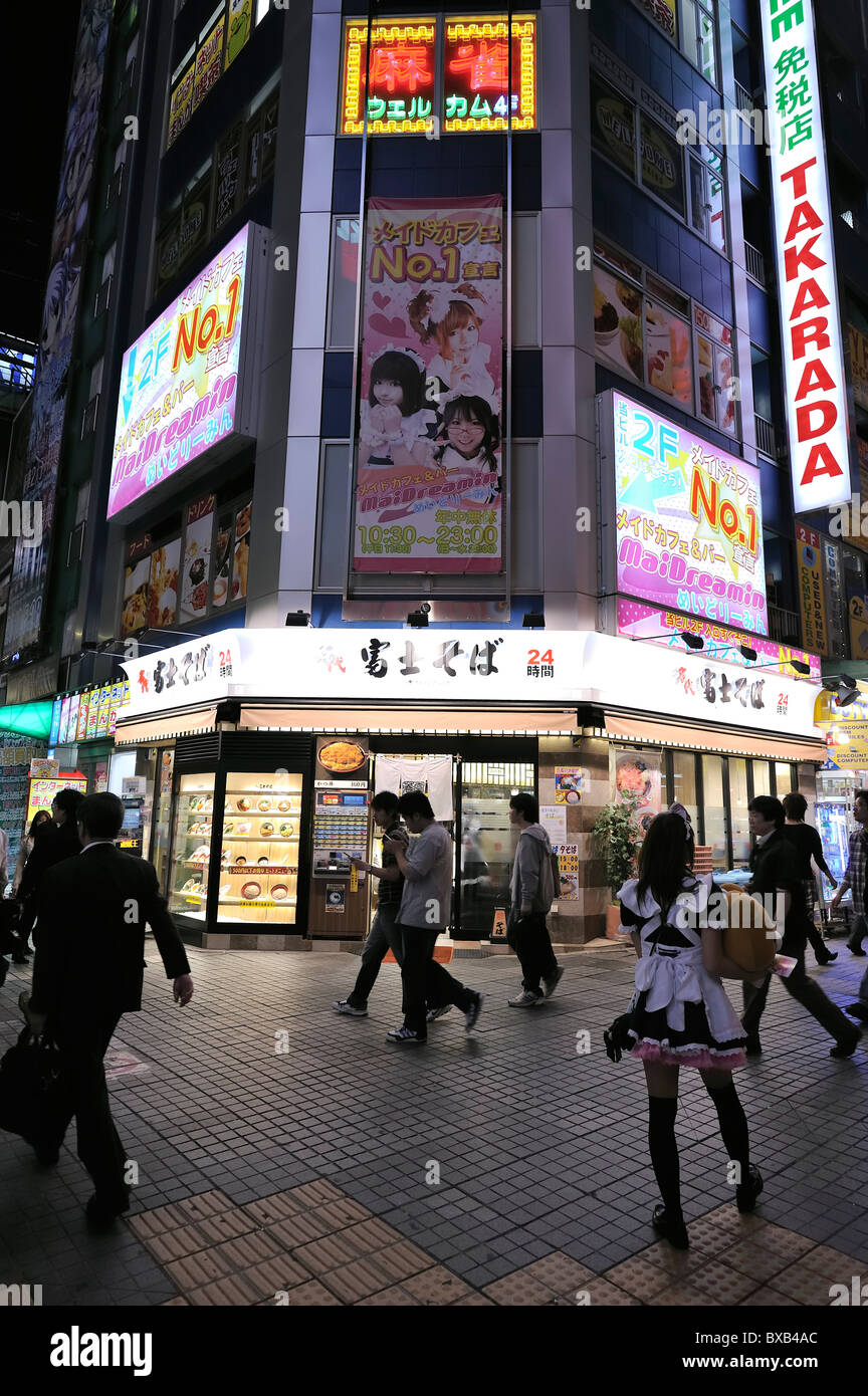 Young, Japanese woman promoting maid cafe in Akihabara at night, Tokyo ...