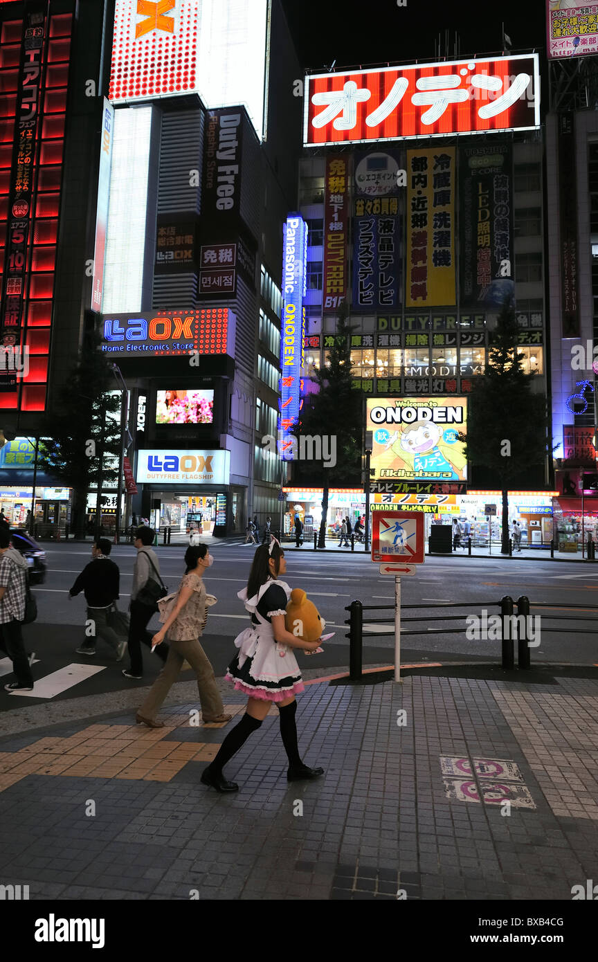 Young, Japanese woman promoting maid cafe in Akihabara at night, Tokyo ...