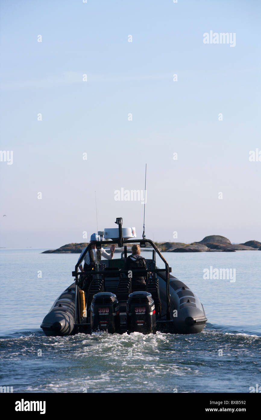 Two people on motorboat Stock Photo - Alamy