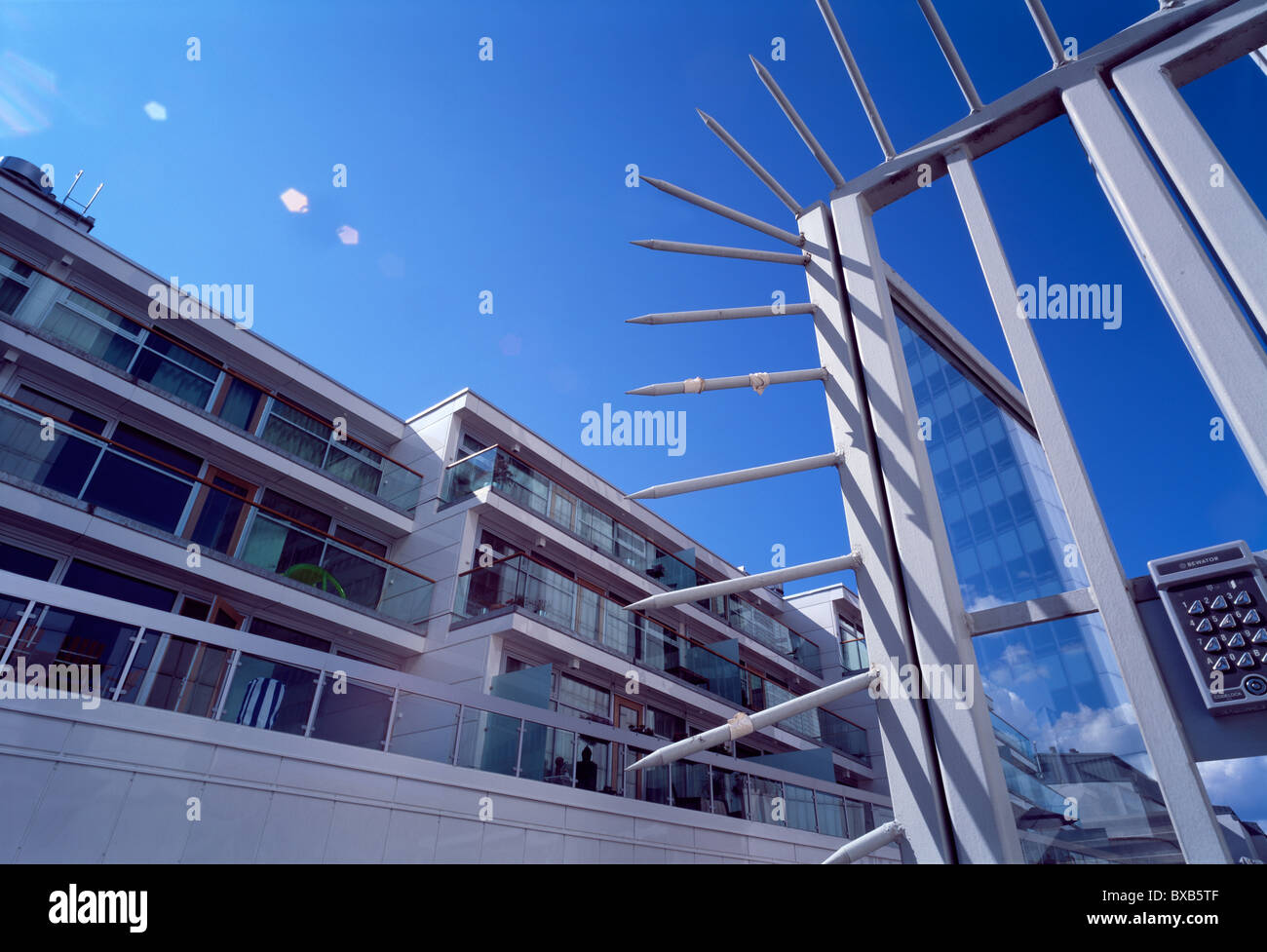 Gate and modern apartment building Stock Photo - Alamy