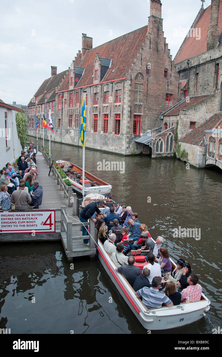 A canal cruise boat prepares to take passengers on a tour of Brugges ...