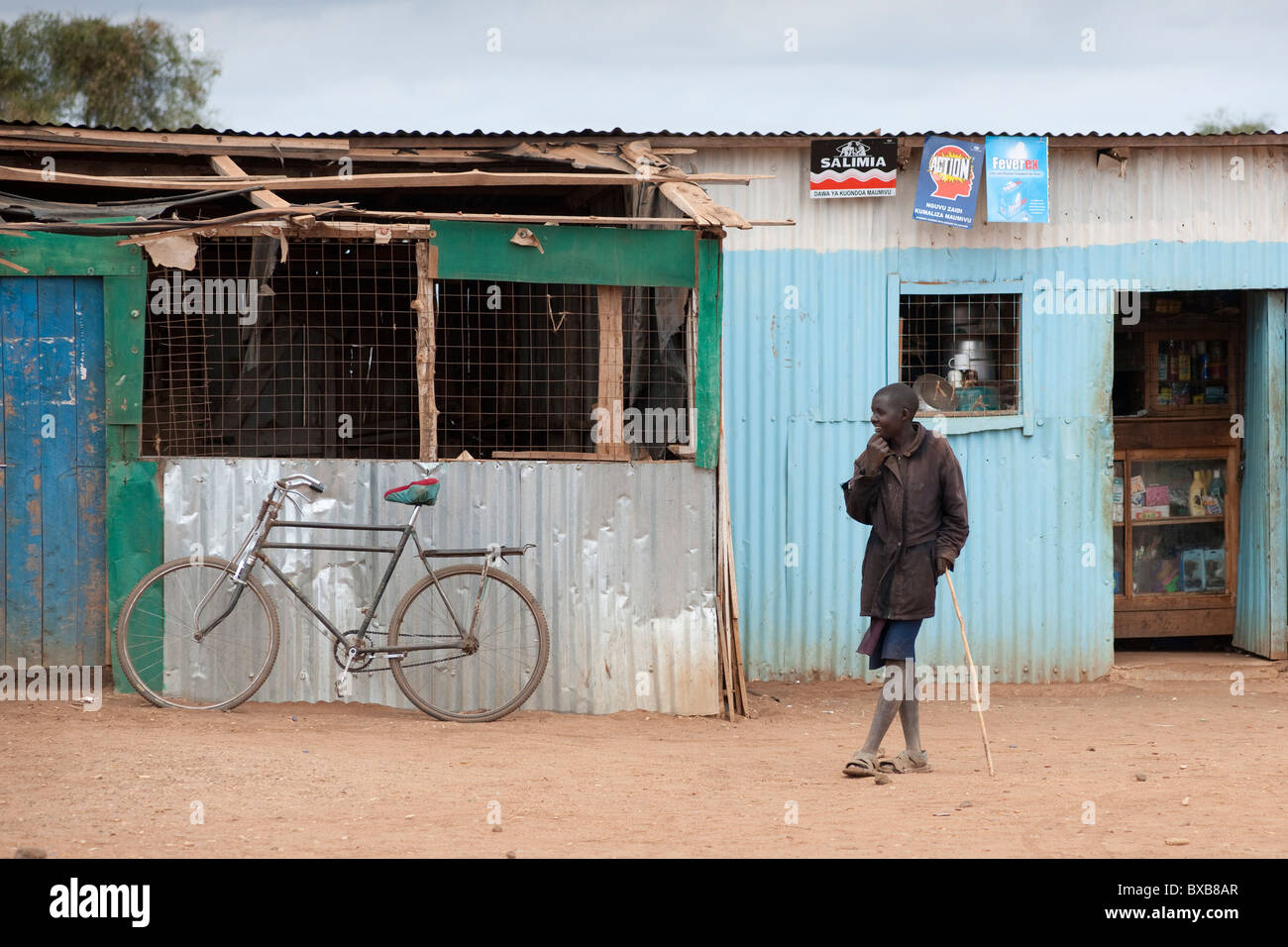 Villager by hut in Kenya Stock Photo - Alamy