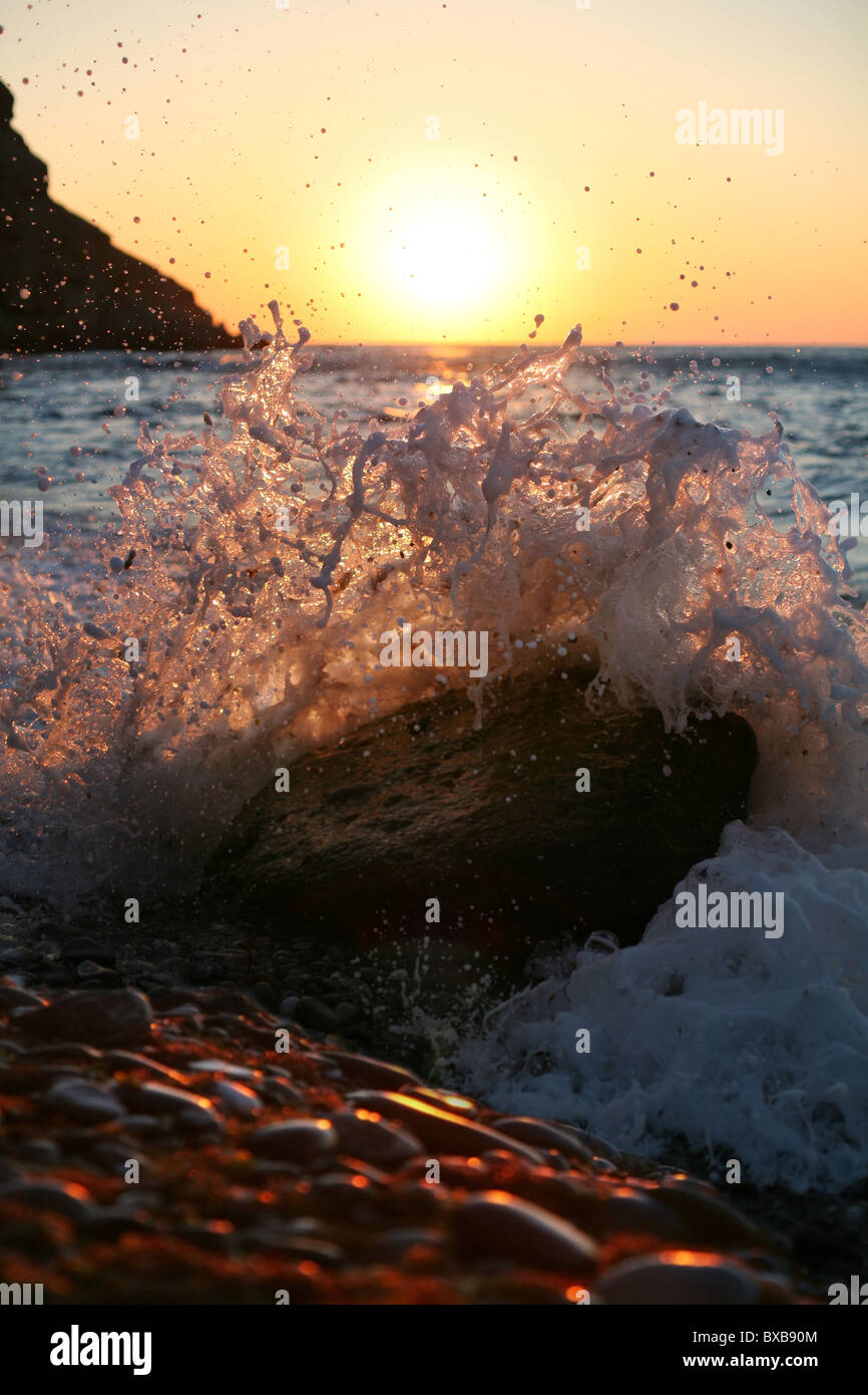 Waves crash on beach sunset hi-res stock photography and images - Alamy