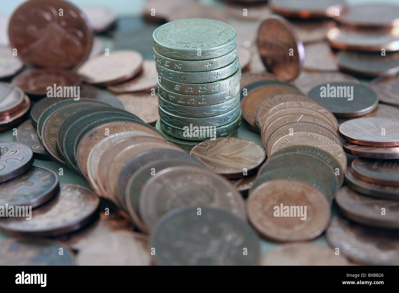 A stack of sterling £1 coins amongst a jumble of 2p and 1p coins Stock ...