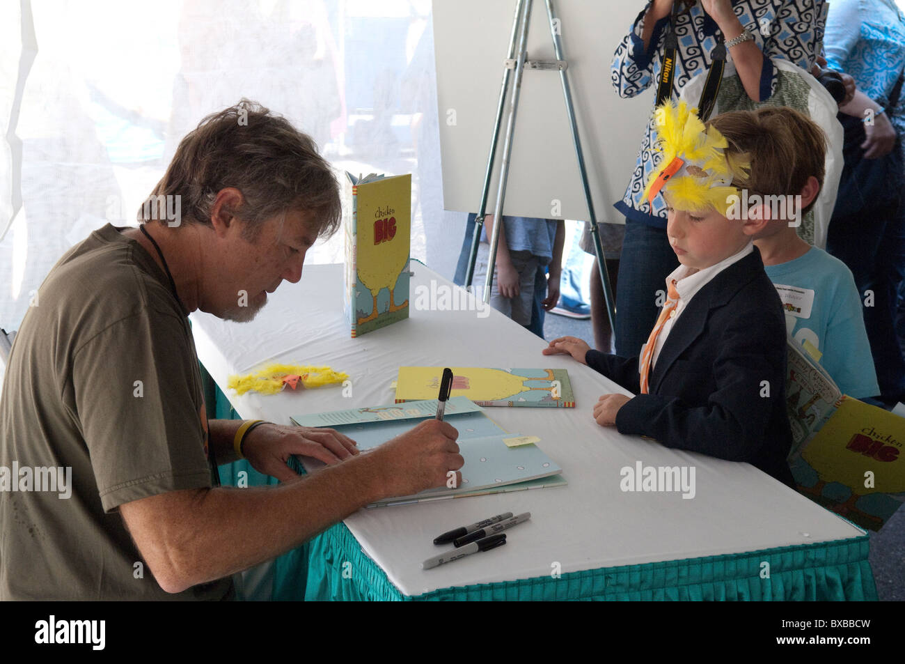 Children's book author/illustrator Keith Graves signs a copy of his ...