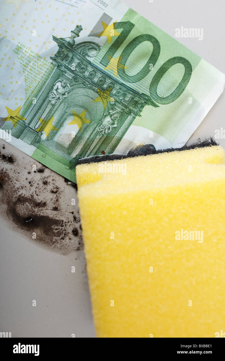 Banknote being cleaned with a sponge, symbolic image for dirty money ...