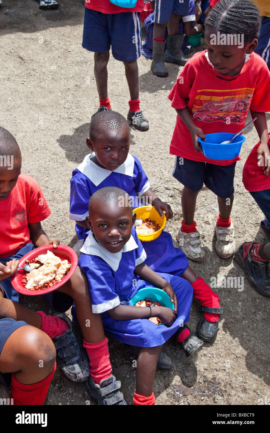 Kids eating food provided at Maji Mazuri School in the Mathare slums ...