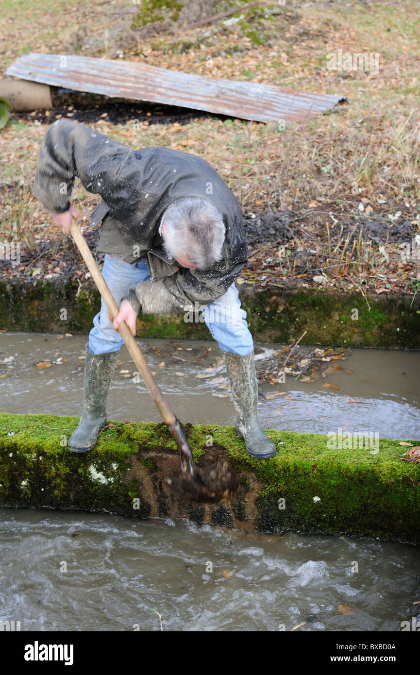 Men preparing to drain and clean a fishing lake in France Stock Photo ...