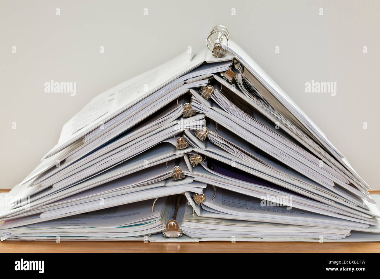 pile of white binders and paper on desktop Stock Photo - Alamy