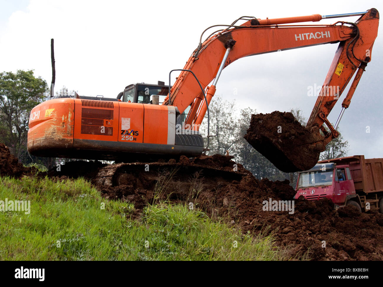 Excavator or digger heavy equipment working on highway construction in ...