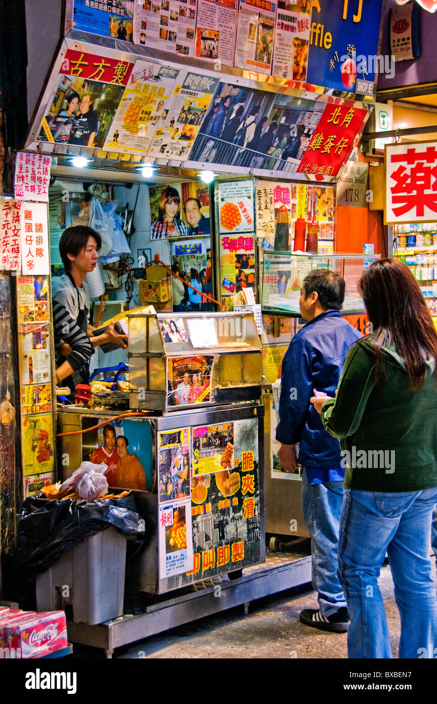Two Asian people waiting in line to buy papers at newsstand Stock Photo ...