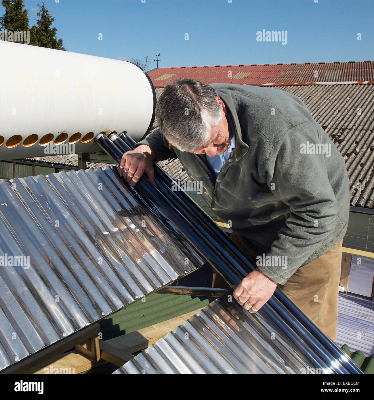 Inserting a solar panel tube to a frame Stock Photo - Alamy