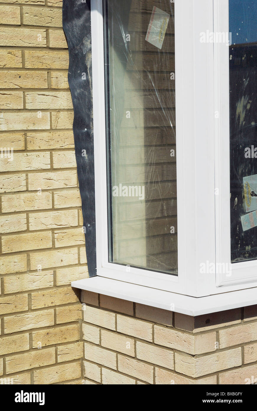 Weather proofing around a modern PVC bay window Stock Photo - Alamy