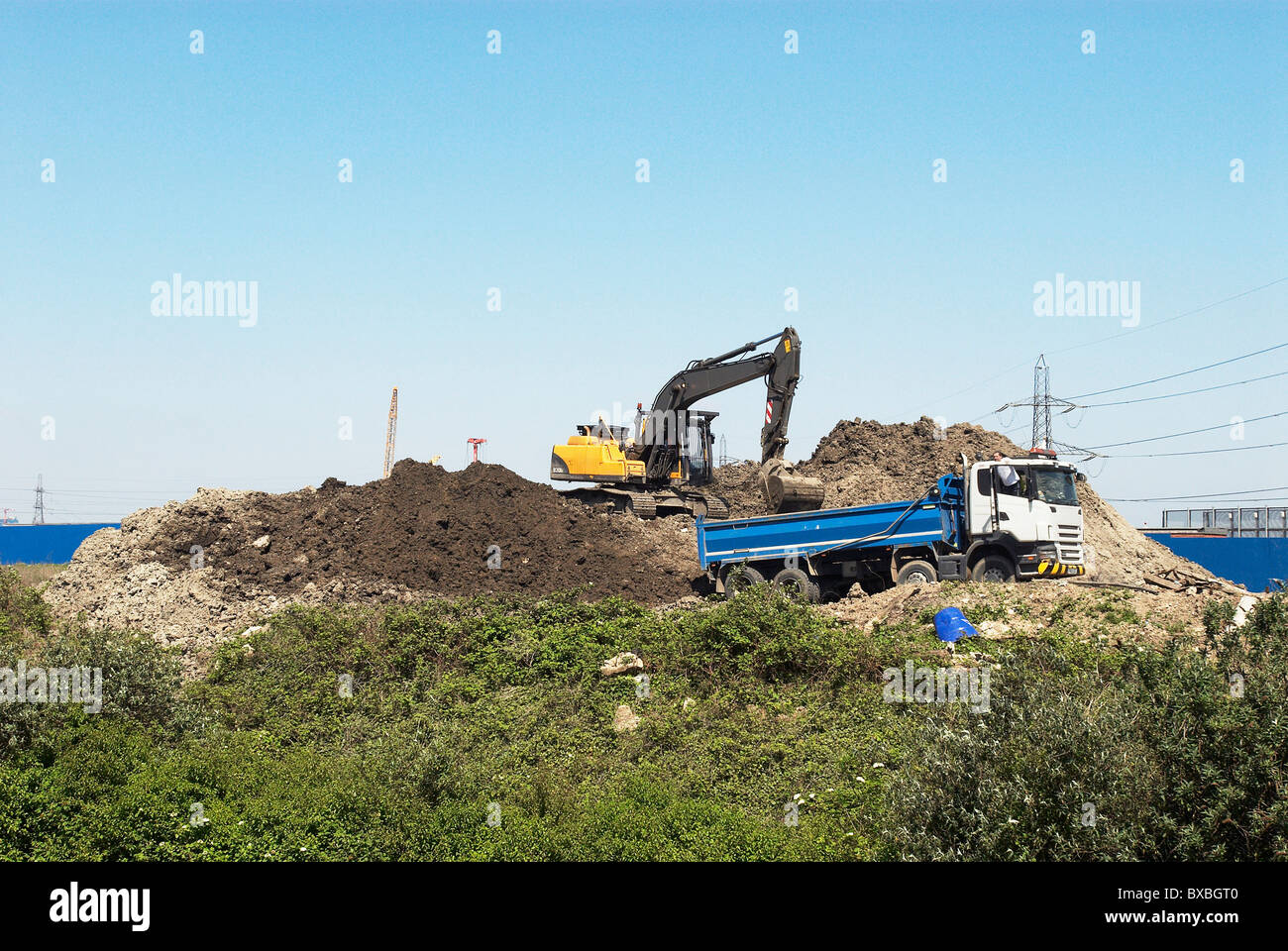 Excavator loading soil onto a dumper truck East London UK Stock Photo ...