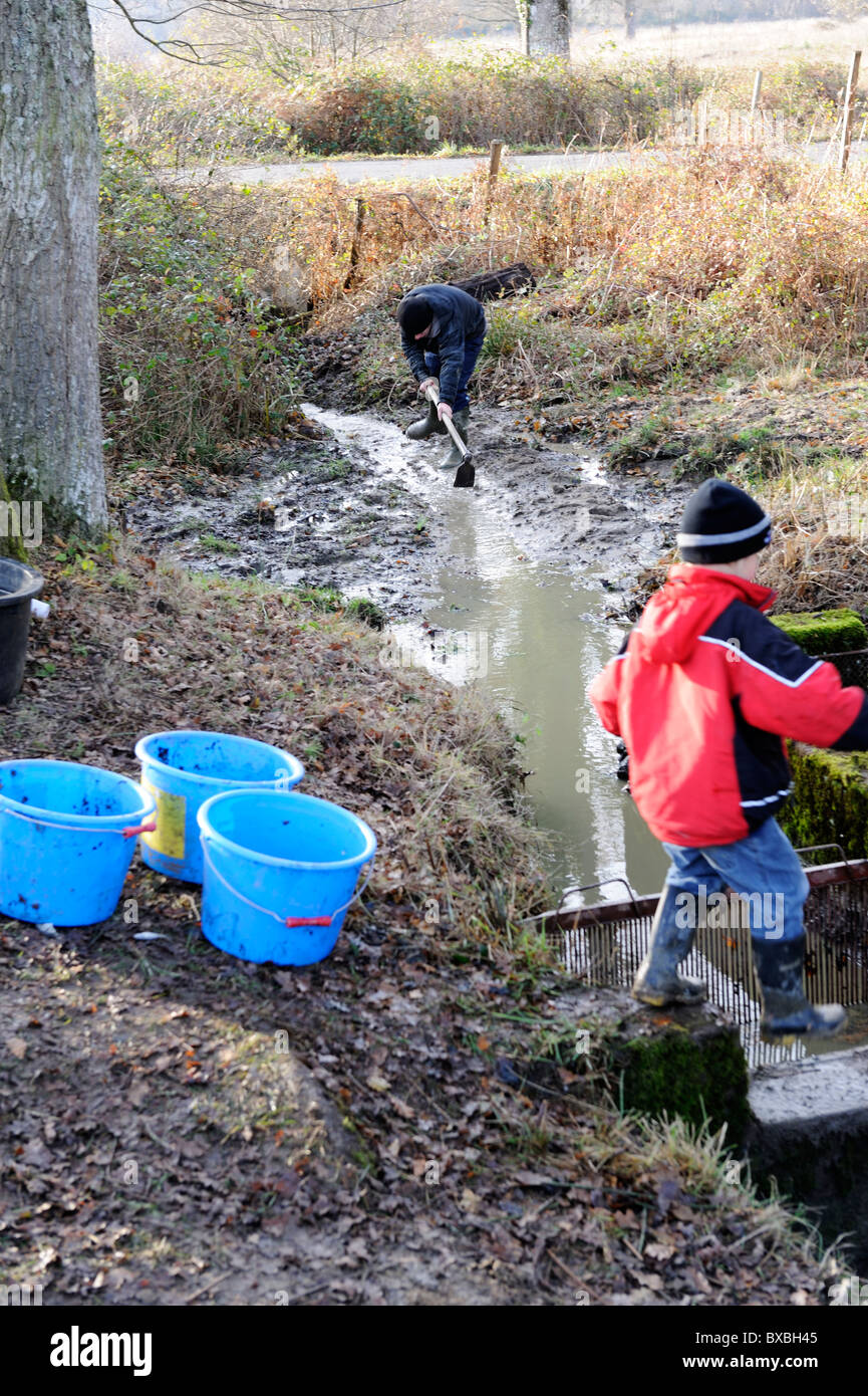 Cleaning a channel for the water to empty out of the lake Stock Photo ...